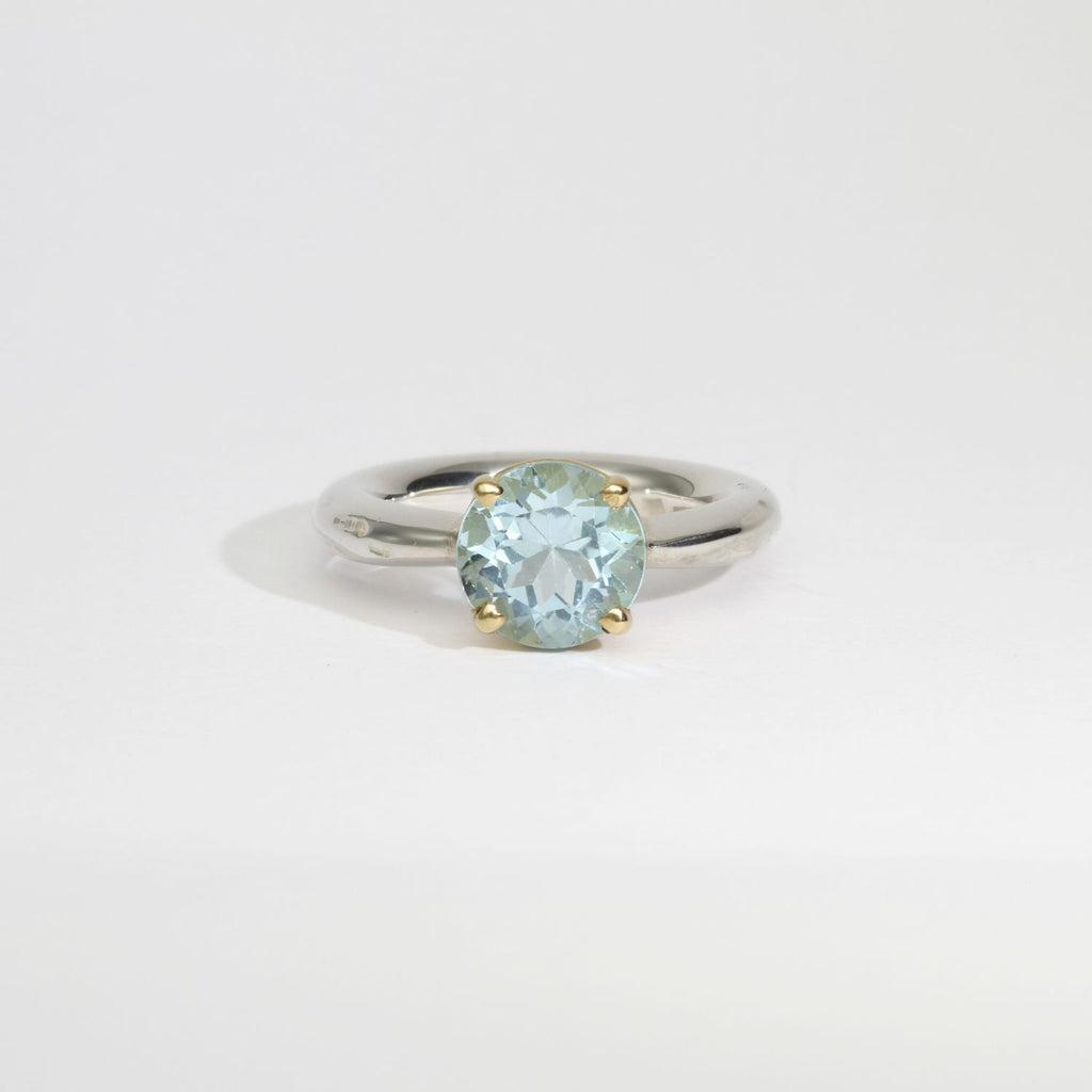 Halo silver ring with a round topaz in a 18ct setting by Charmian Otta ...